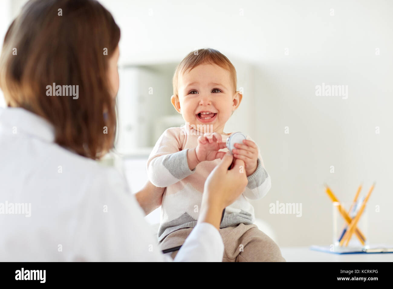 happy doctor or pediatrician with baby at clinic Stock Photo - Alamy
