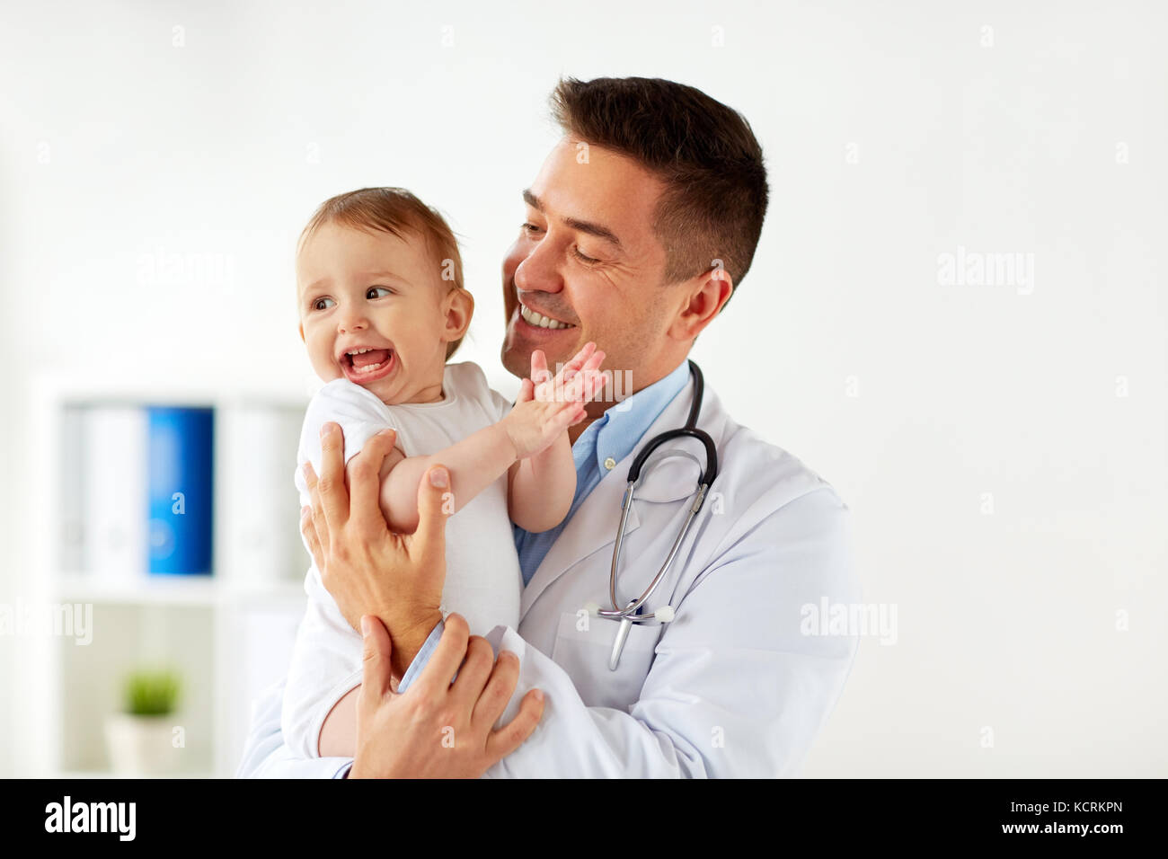 happy doctor or pediatrician with baby at clinic Stock Photo - Alamy