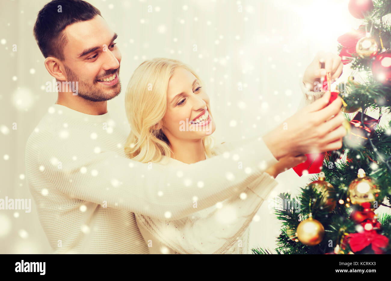 happy couple decorating christmas tree at home Stock Photo - Alamy