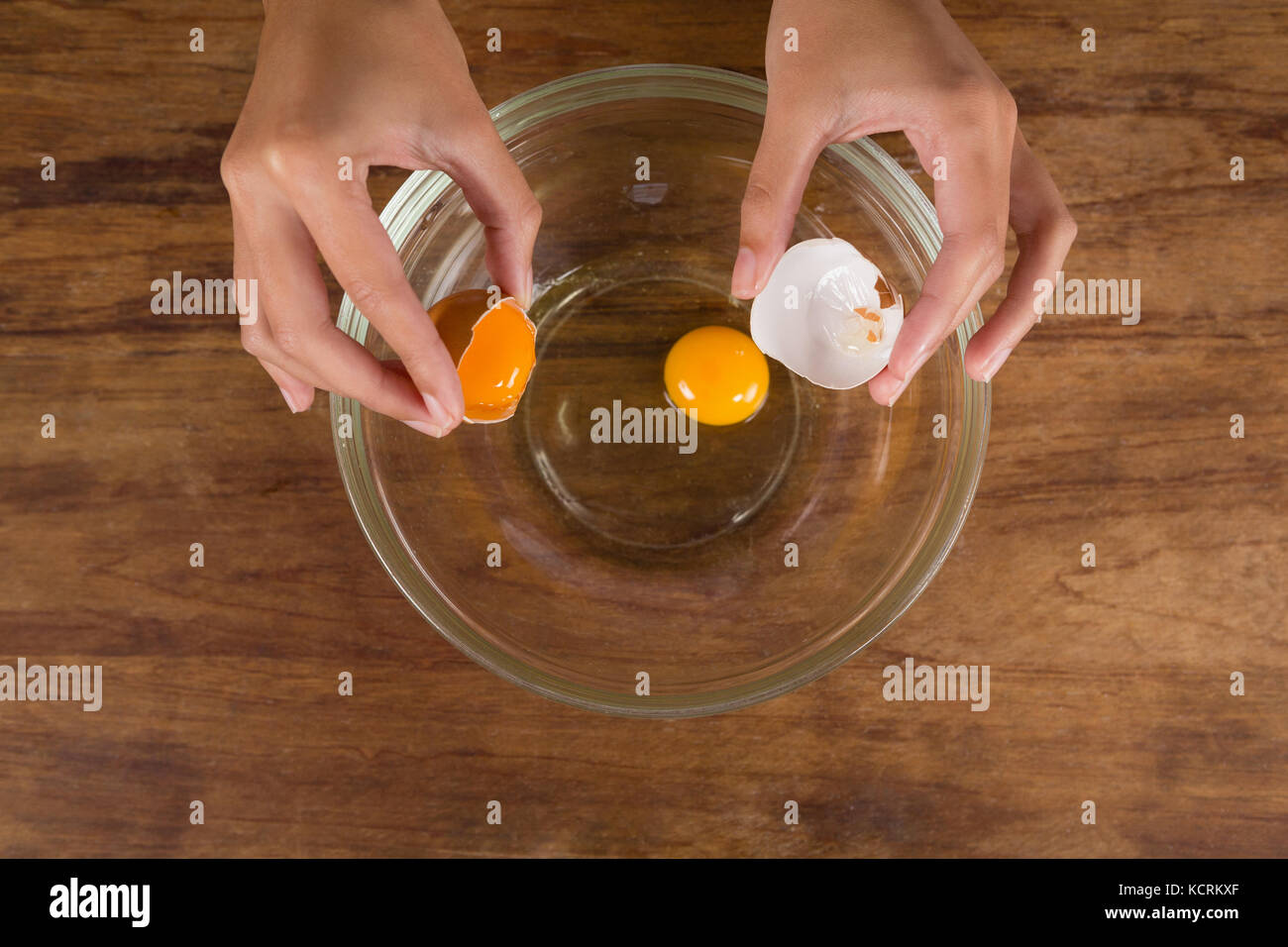 Mid-section of man breaking eggs in bowl Stock Photo - Alamy