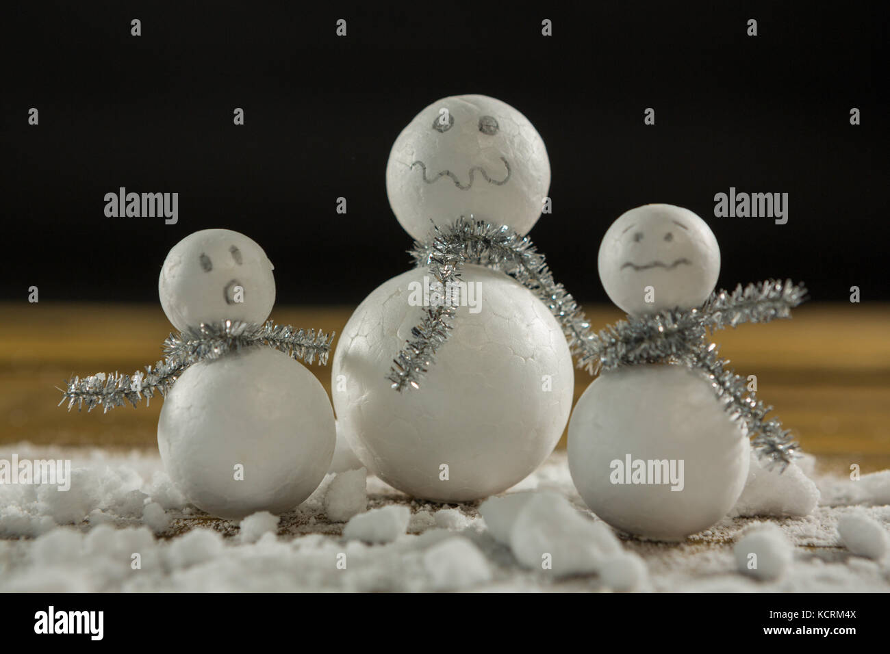 Close up of artificial snowman decoration on table against black ...