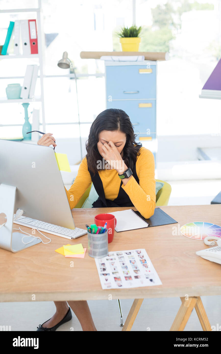 Depressed female executive working on computer in the office Stock ...