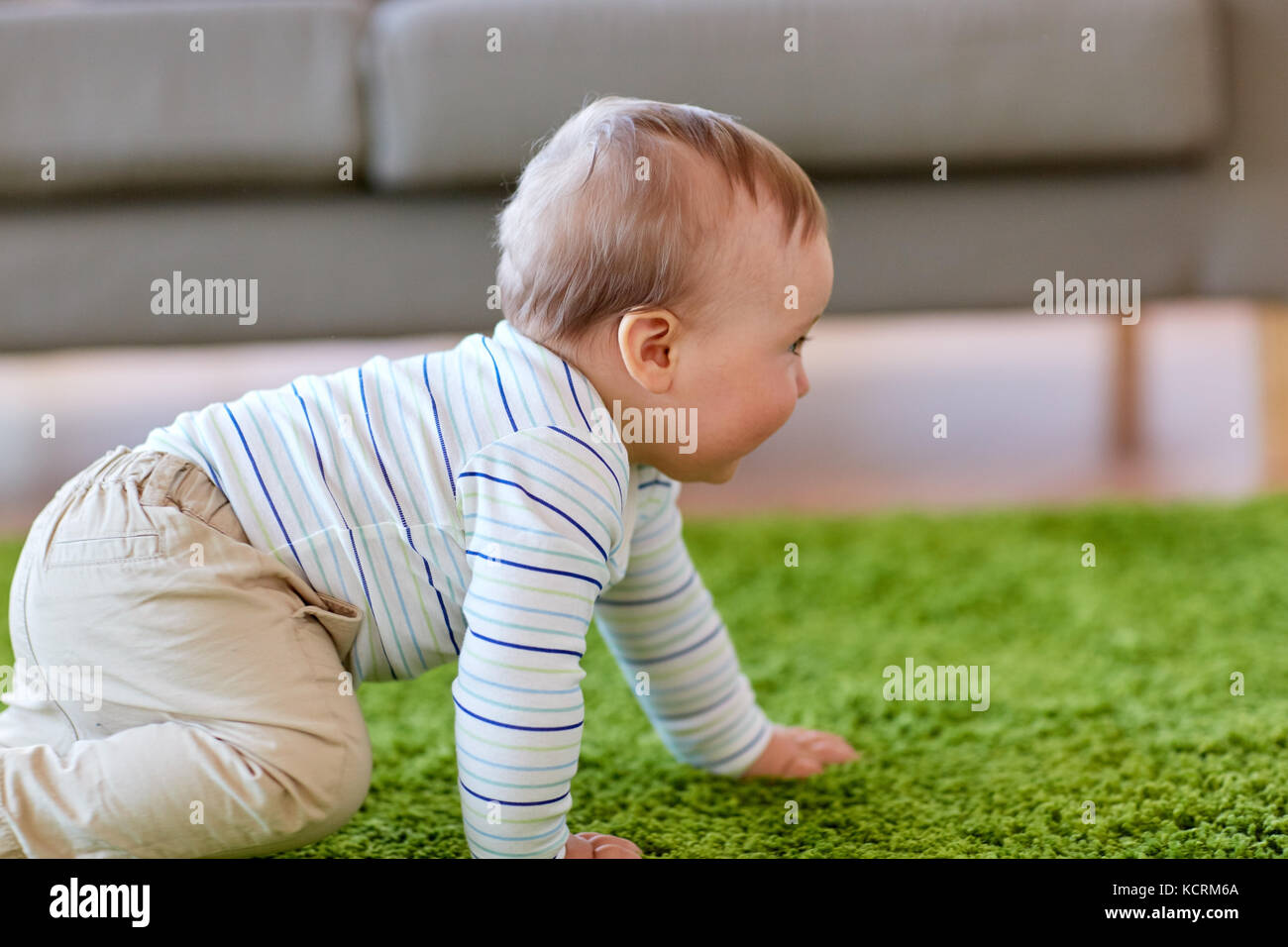 baby boy crawling on floor at home Stock Photo - Alamy