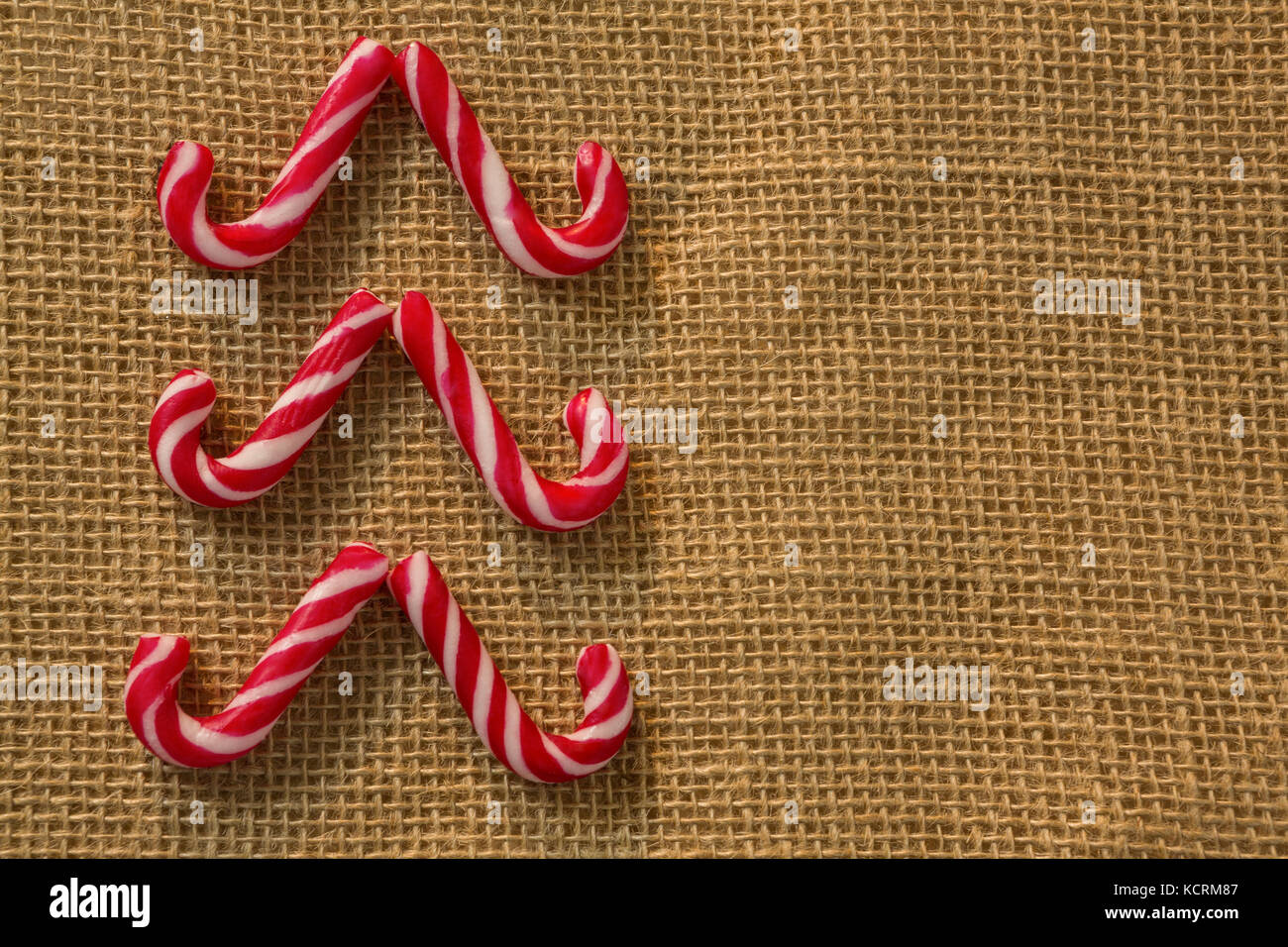 Overhead view of candy canes arranged on burlap Stock Photo - Alamy