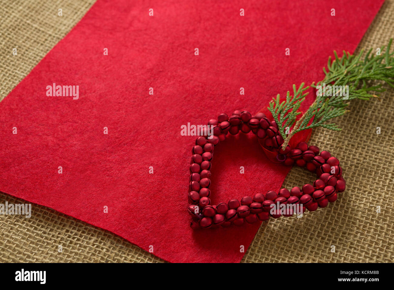 Jingle bells in heart shape decoration with pine twig on burlap Stock ...