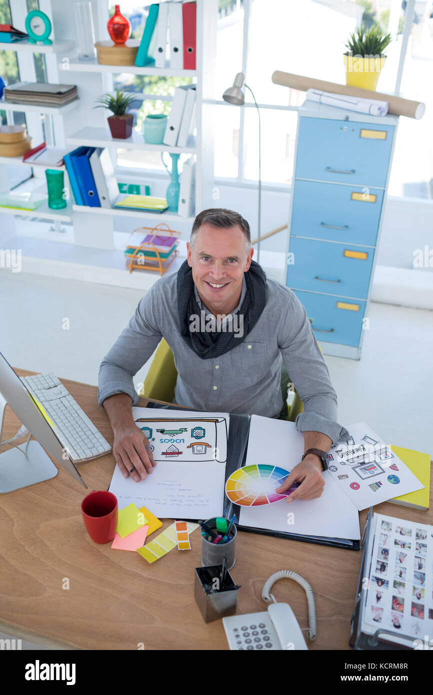 Male graphic designer working at desk in the office Stock Photo - Alamy