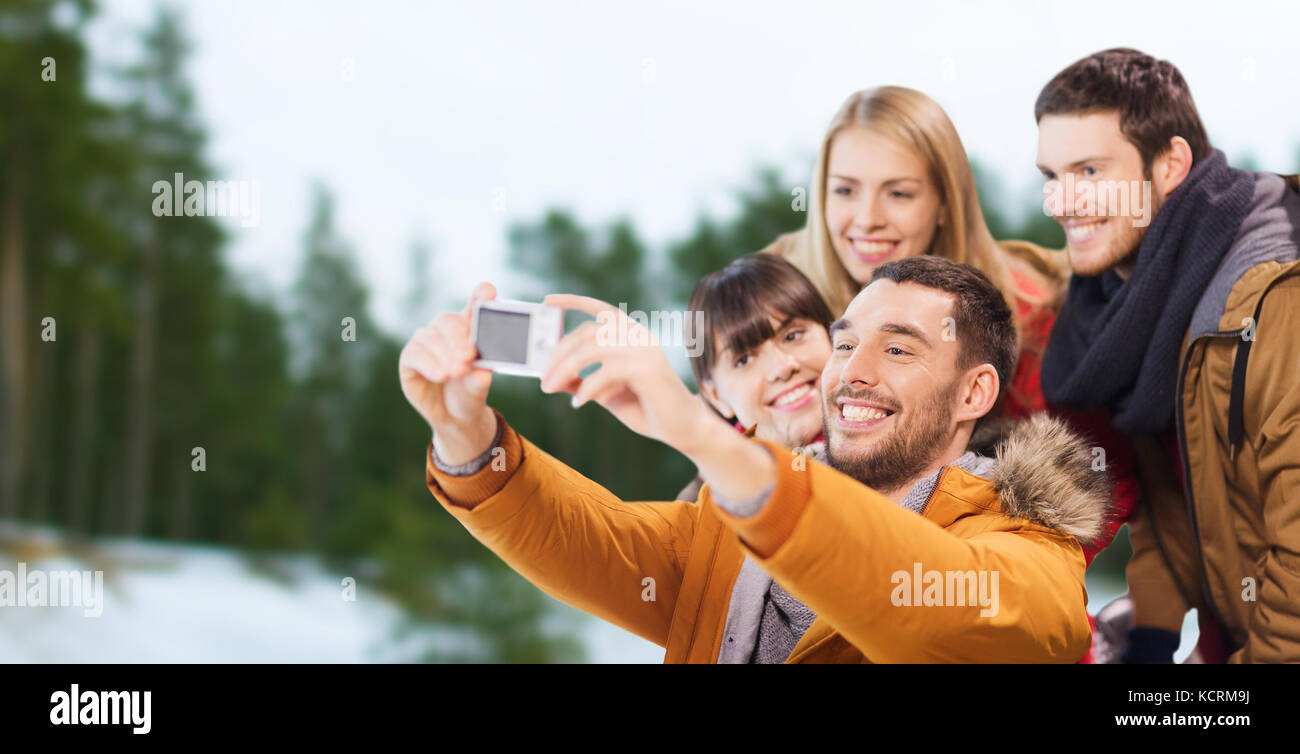 happy friends with camera on skating rink Stock Photo - Alamy