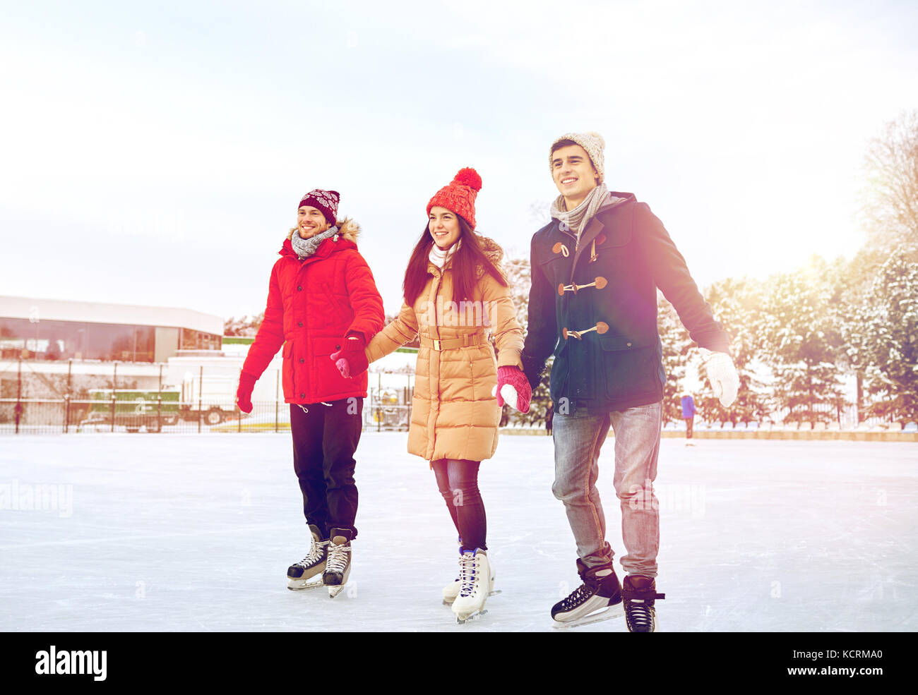 happy friends ice skating on rink outdoors Stock Photo - Alamy