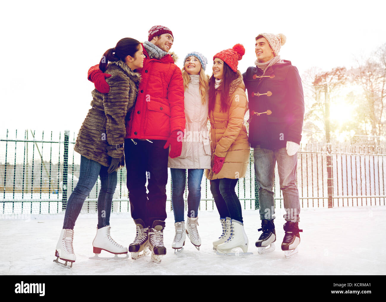 happy friends ice skating on rink outdoors Stock Photo - Alamy