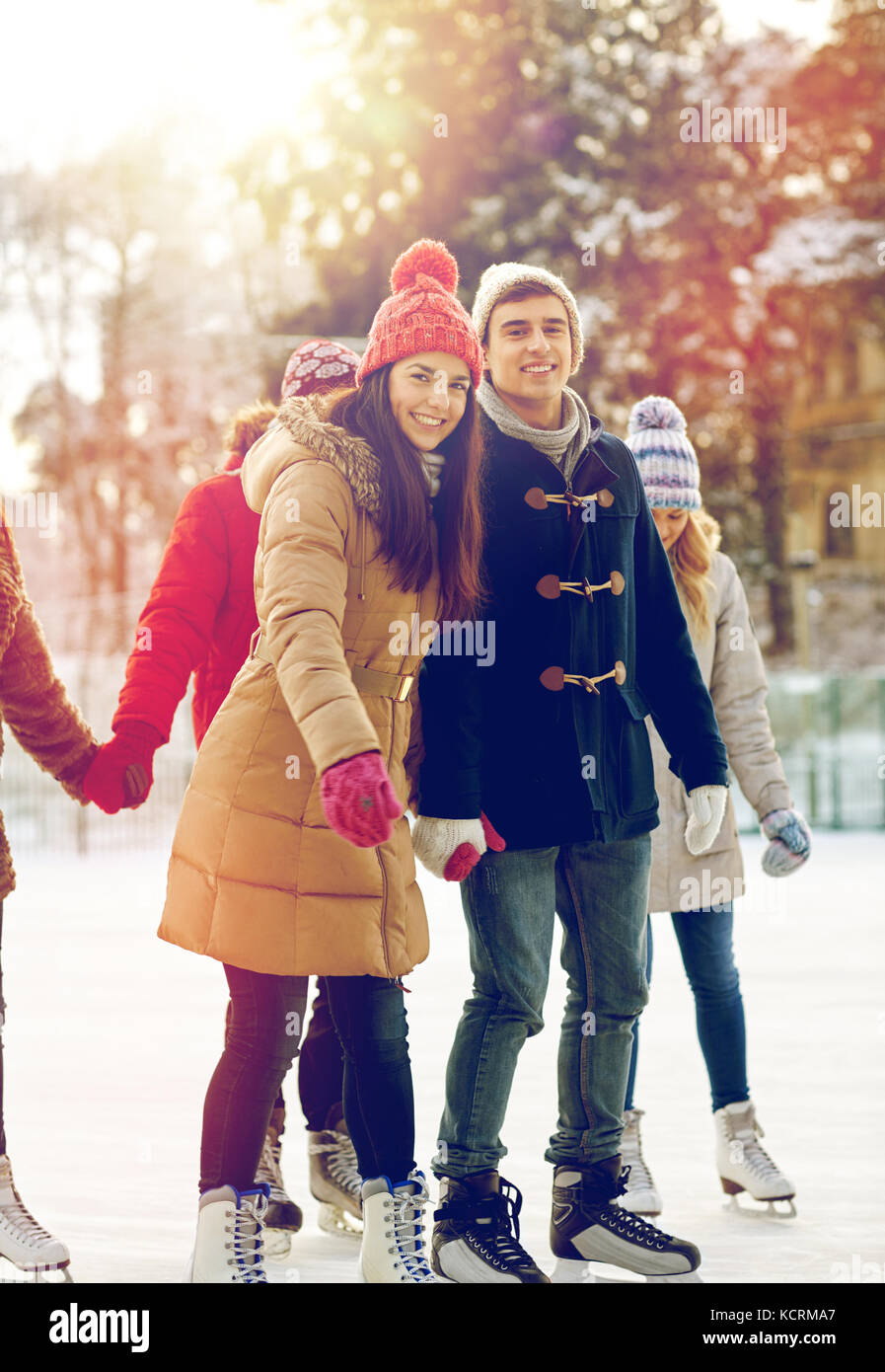 happy friends ice skating on rink outdoors Stock Photo - Alamy
