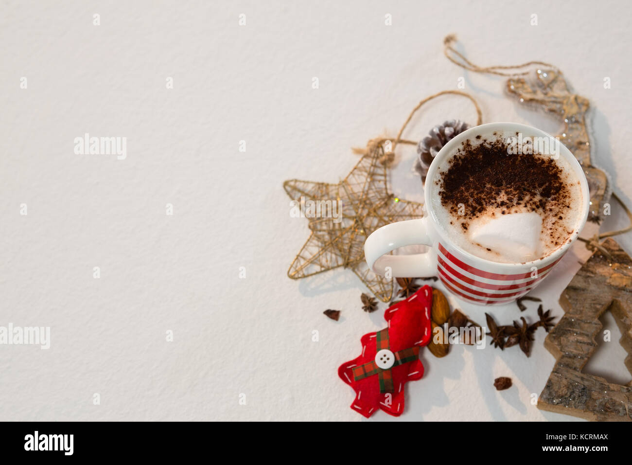 Coffee with cinnamon powder and christmas decorations on white ...