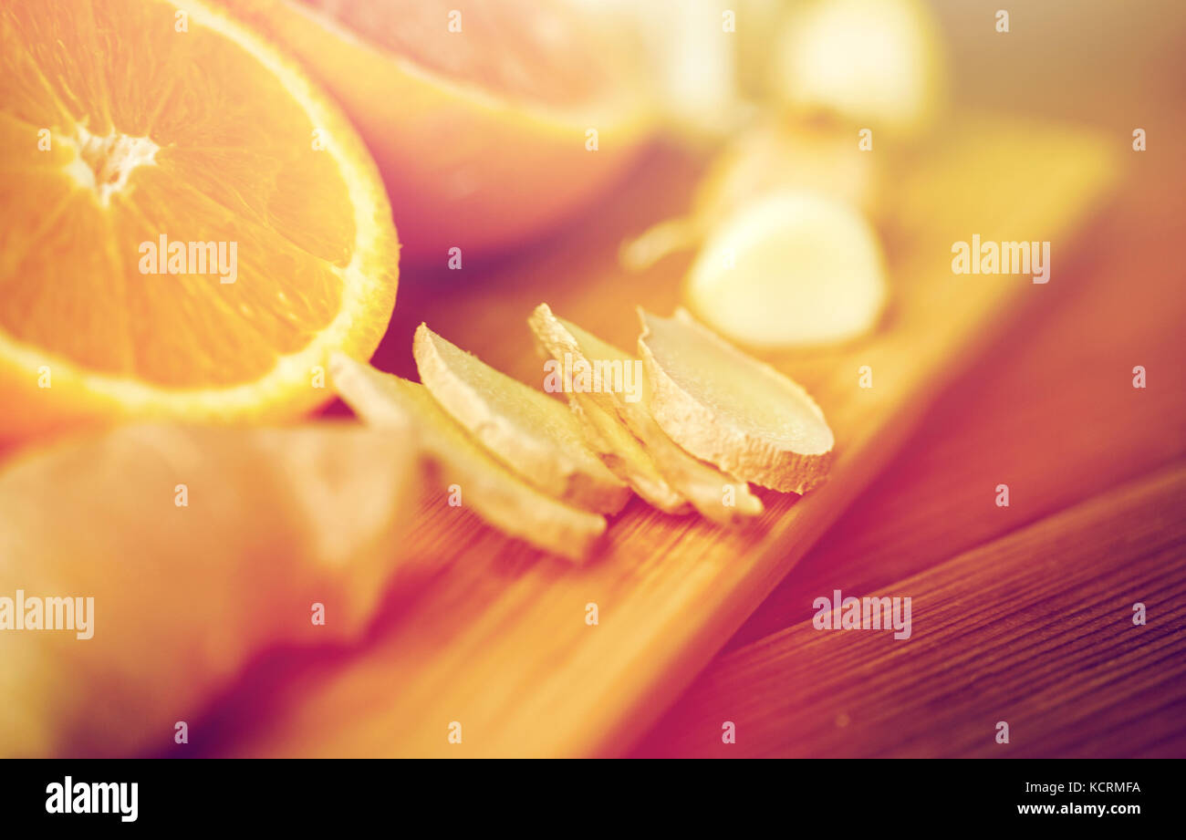 ginger, garlic and orange on wooden board Stock Photo - Alamy