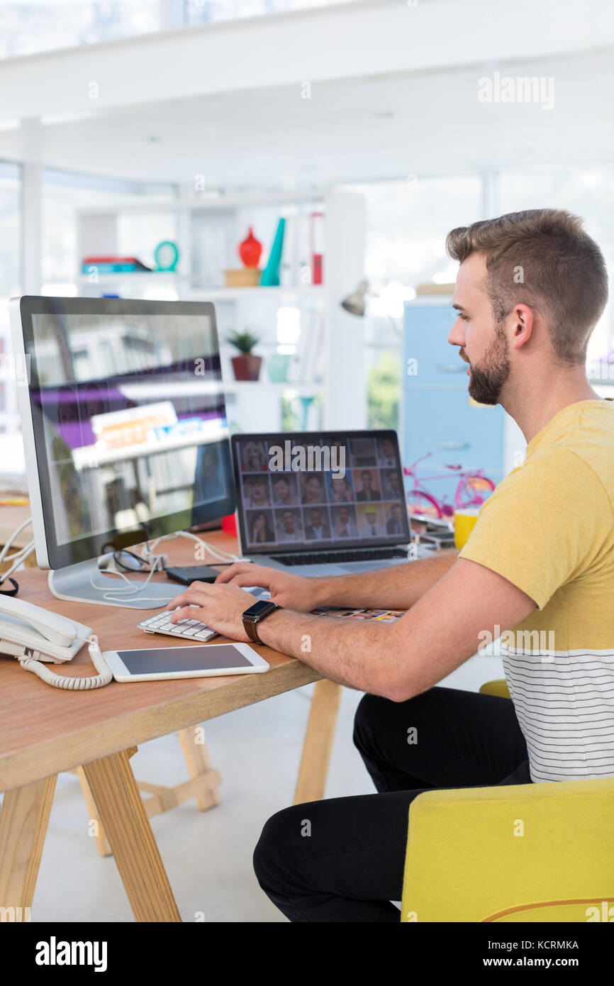 Male executive working on computer at desk in the office Stock Photo ...