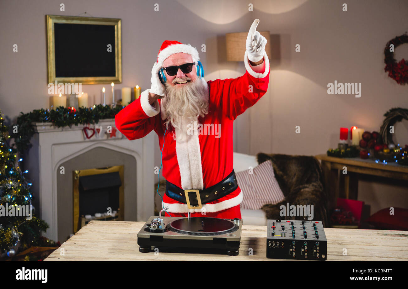 Santa claus playing a dj against white background Stock Photo - Alamy