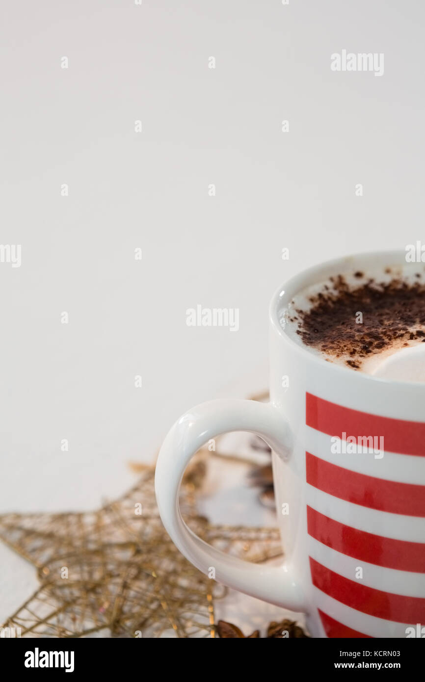 Coffee with cinnamon powder and christmas decorations on white ...