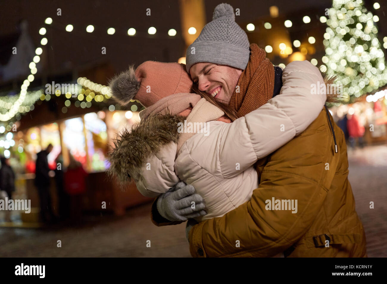 happy couple hugging at christmas tree Stock Photo - Alamy