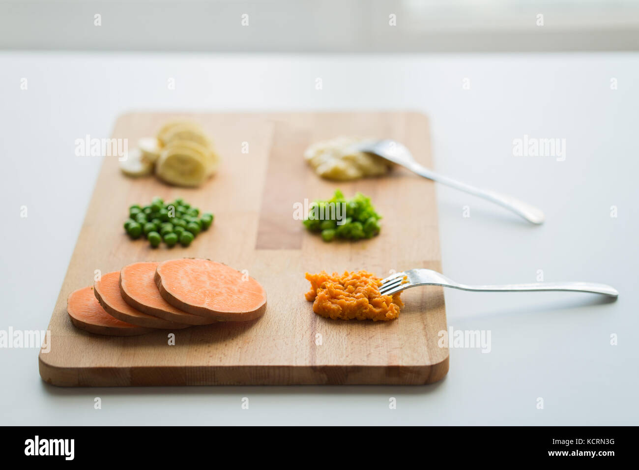 mashed fruits and vegetables with forks on board Stock Photo - Alamy