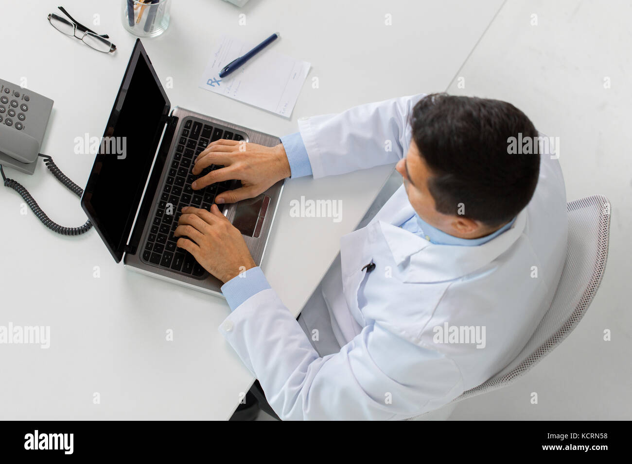 Middle aged doctor typing on hi-res stock photography and images - Alamy