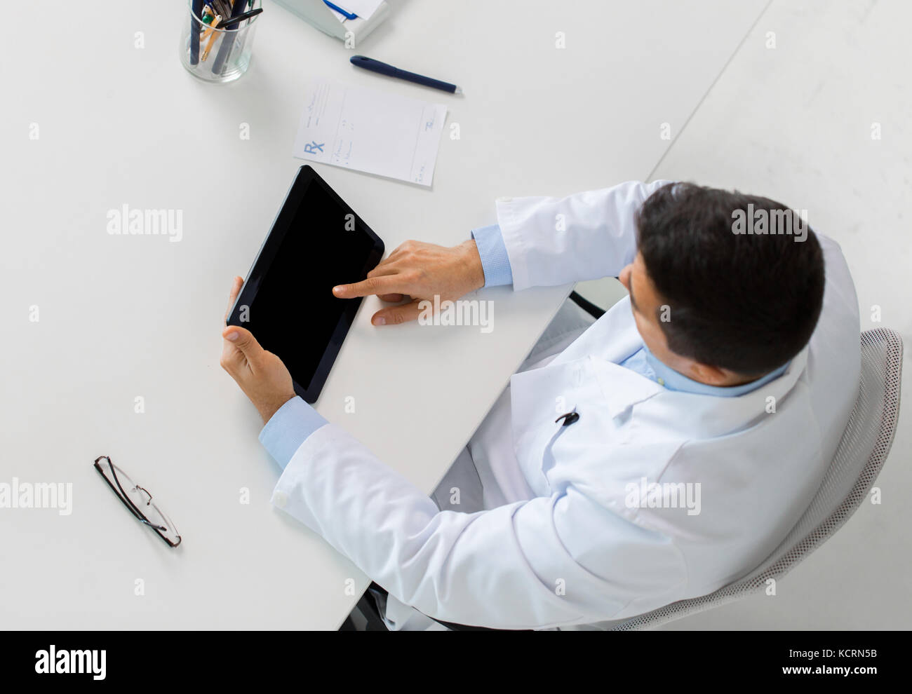 doctor with tablet pc and prescription at clinic Stock Photo - Alamy