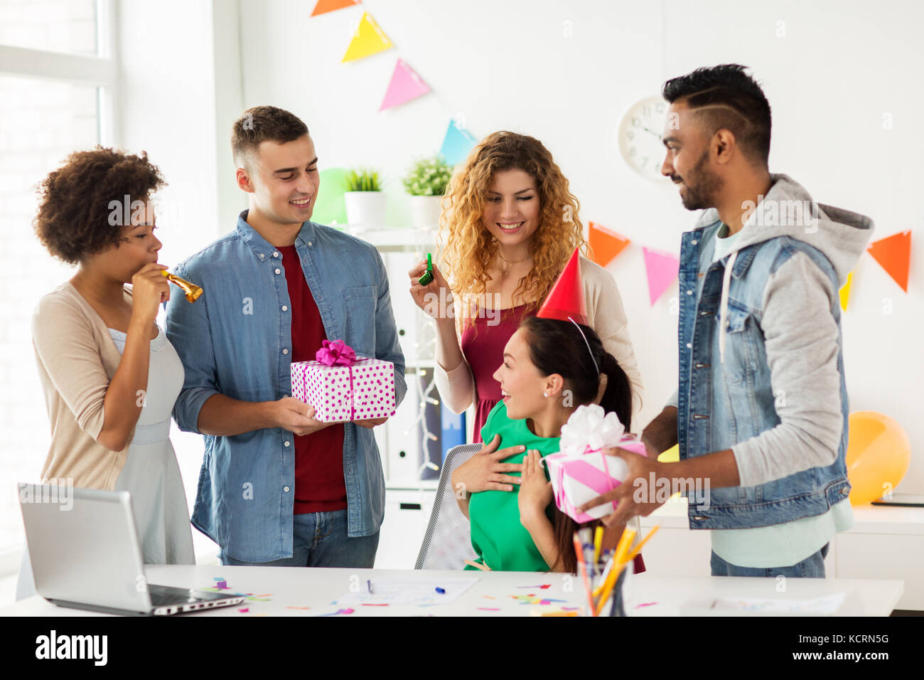 team greeting colleague at office birthday party Stock Photo - Alamy
