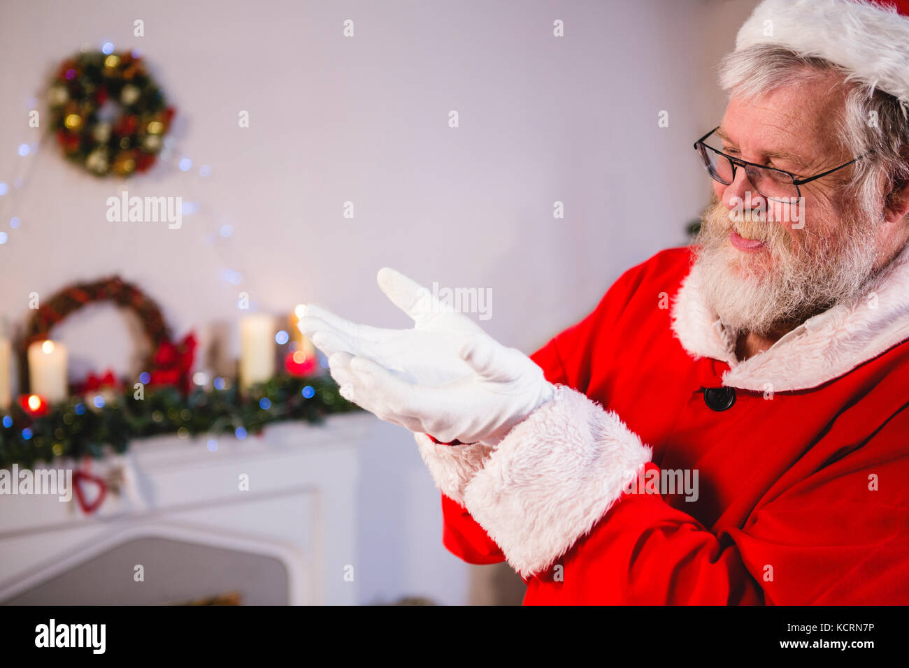 Santa standing with his hands cupped at home Stock Photo - Alamy