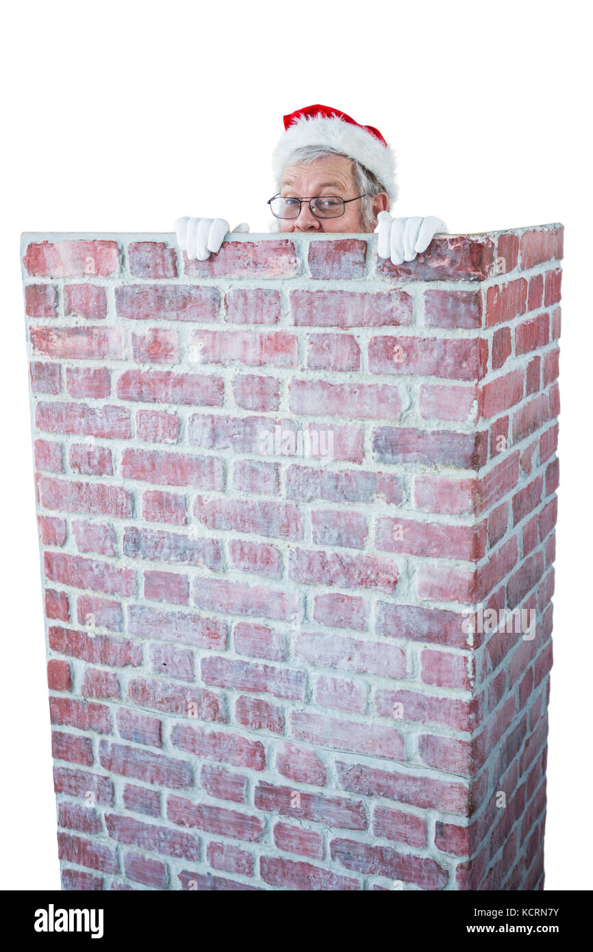 Santa claus hiding behind a chimney against white background Stock ...