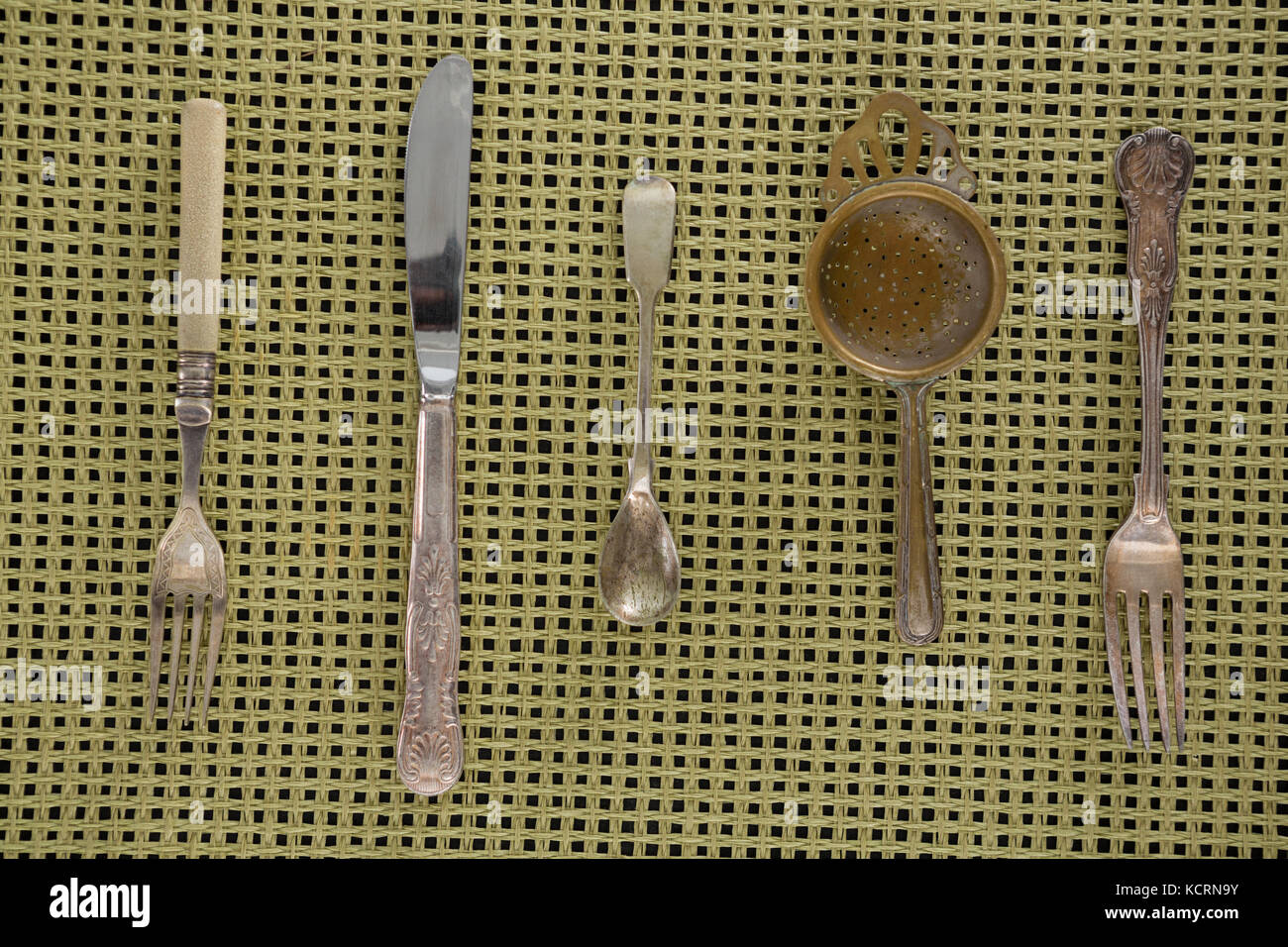 Close-up of spoons, fork, butter knife and strainer on place mat Stock ...