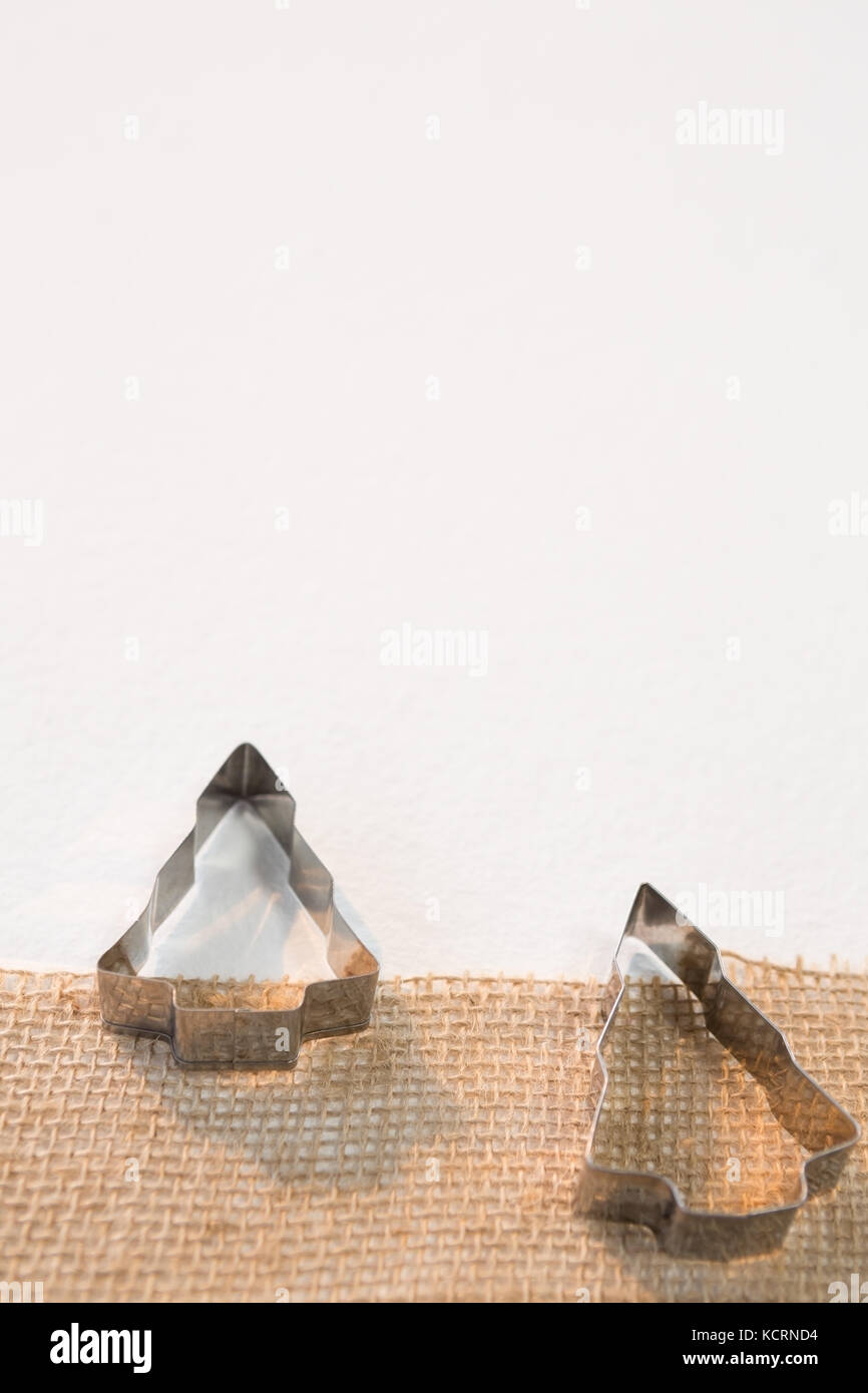 Close-up of cookie cutters on textile against white background Stock ...