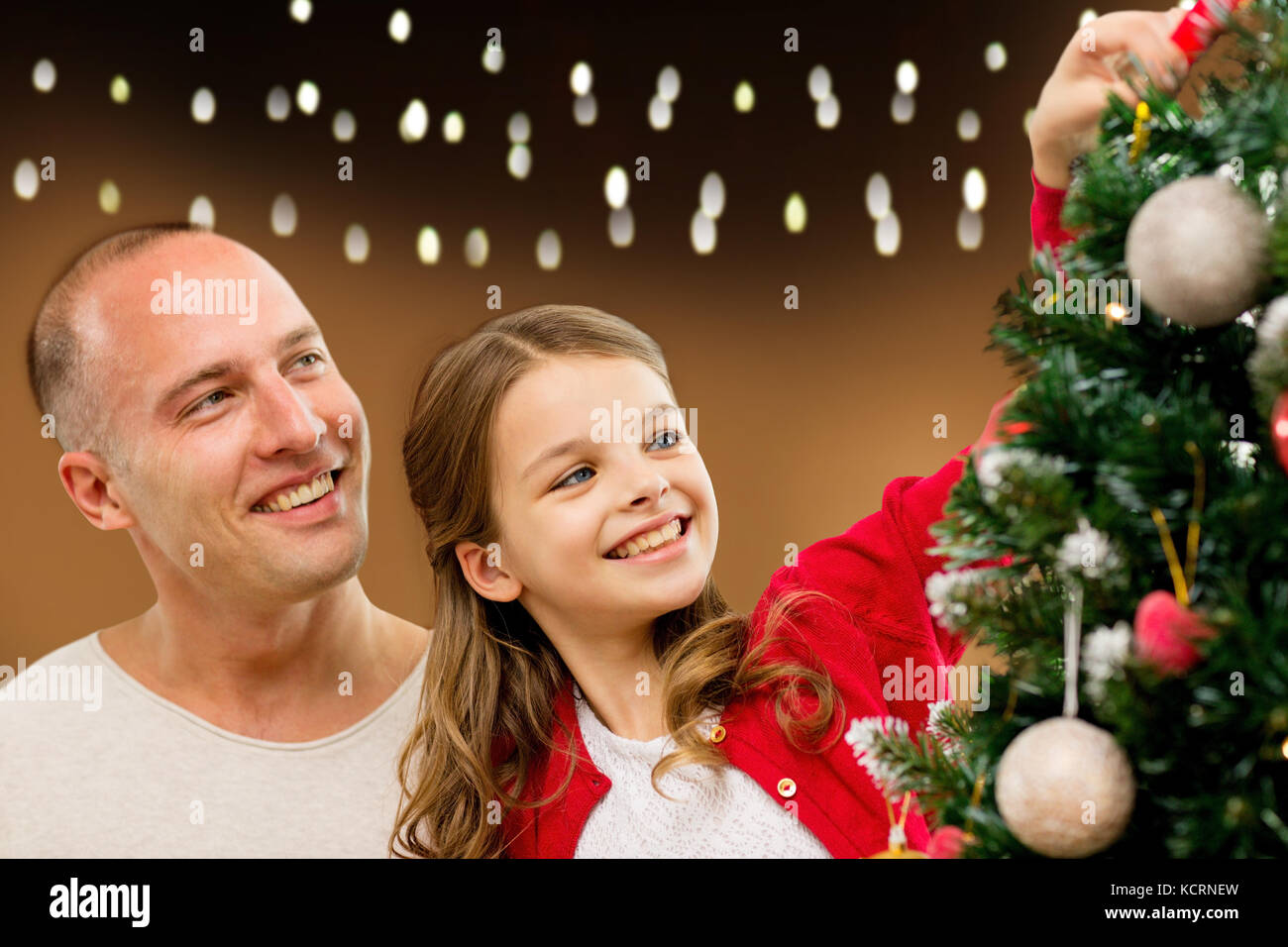 happy family decorating christmas tree at home Stock Photo - Alamy