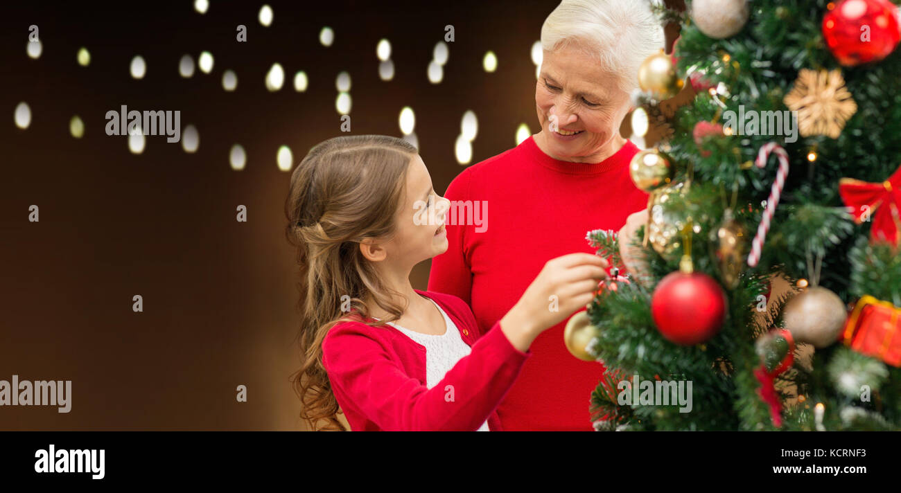 happy family decorating christmas tree Stock Photo - Alamy