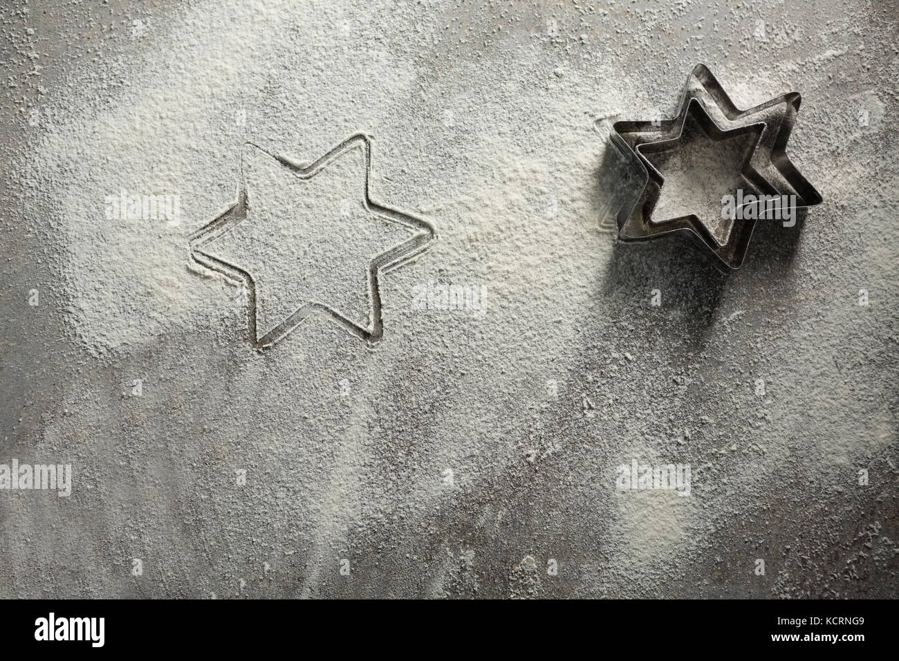 Overhead of star shape cutter on flour Stock Photo - Alamy