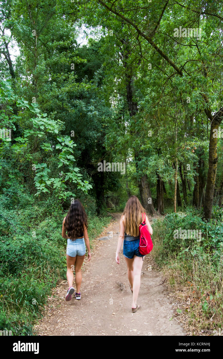 Two beautiful women hiking in nature on a mountain road Stock Photo - Alamy