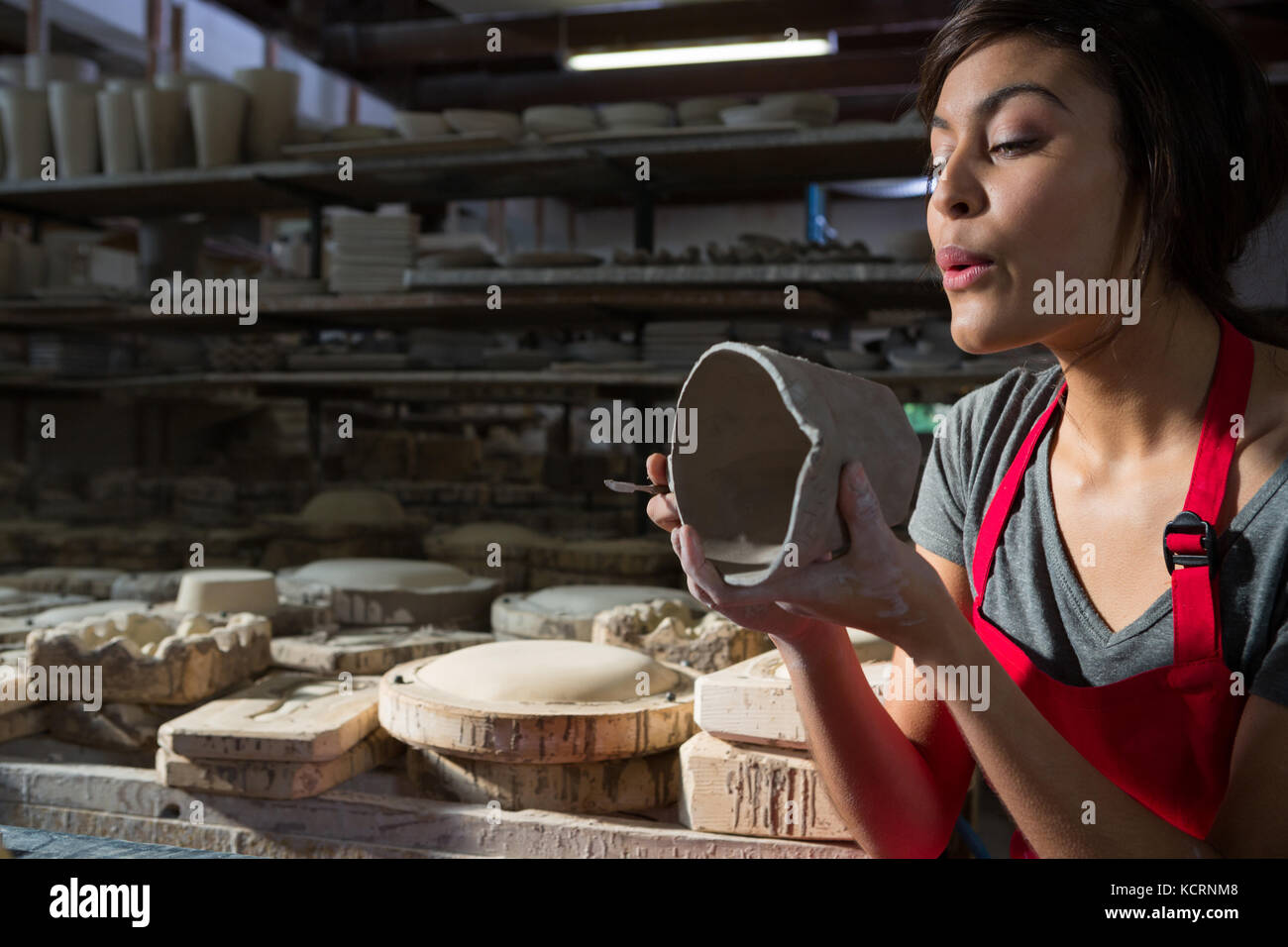 Female potter preparing mug in pottery workshop Stock Photo - Alamy