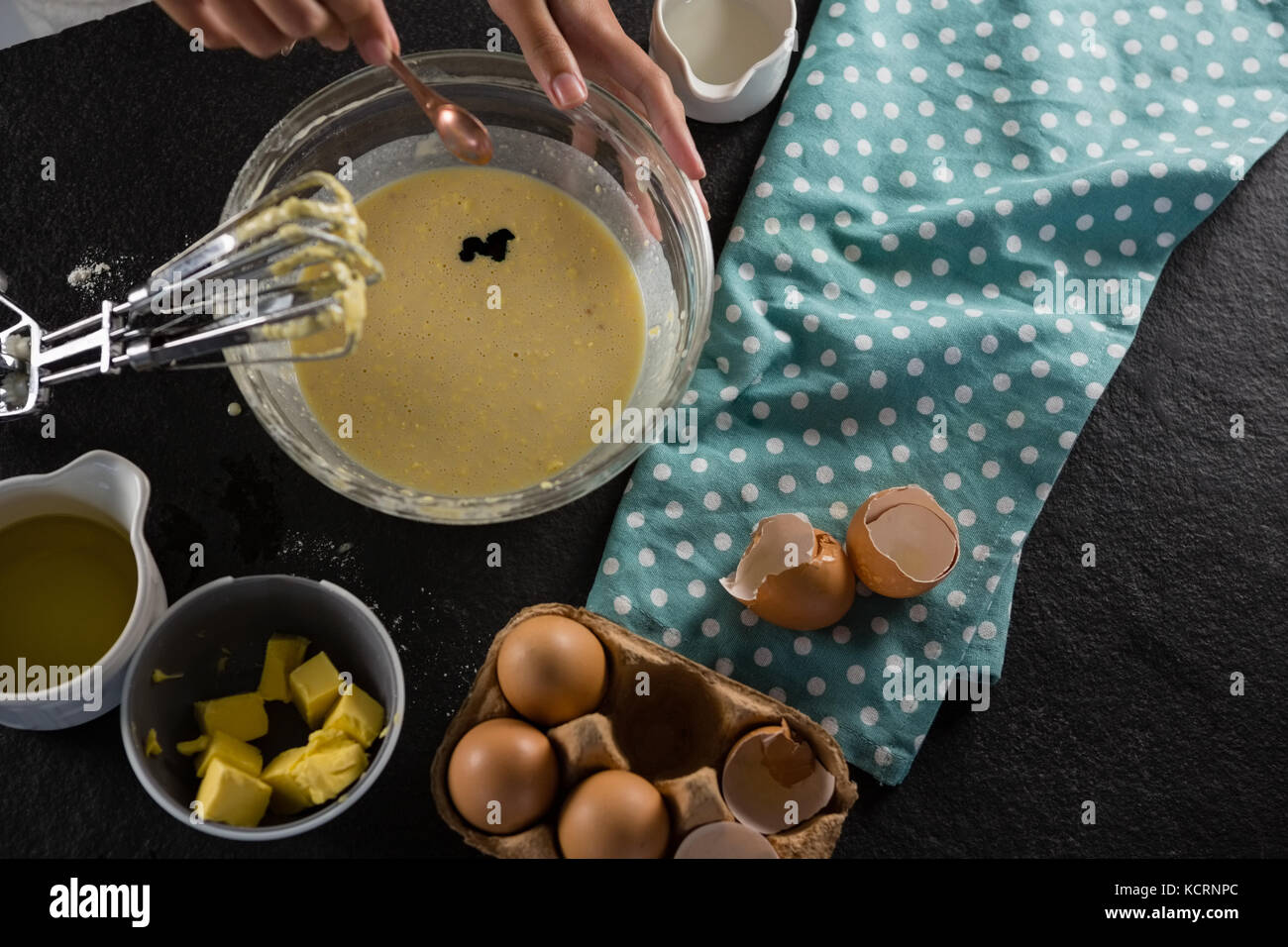Over head view of woman adding food color to a bowl of batter Stock ...