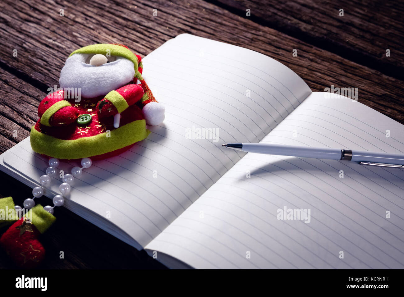 Close-up of handmade santa, pen and organizer on wooden plank Stock ...