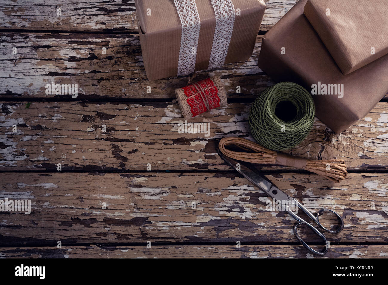 Overhead of gift boxes with wrapping material on wooden plank Stock ...