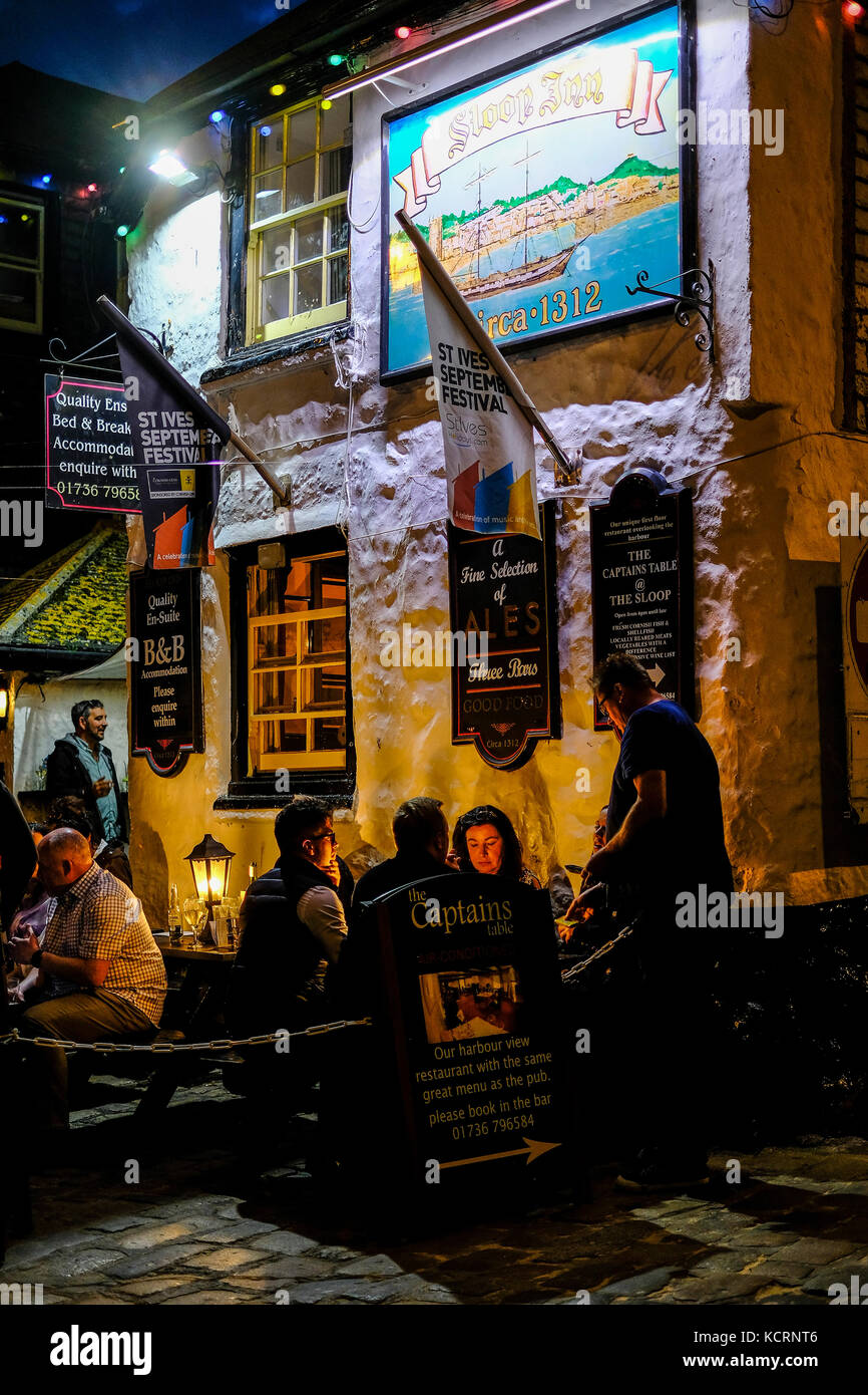 People sitting outside at The Sloop Inn St Ives on a mild evening in ...