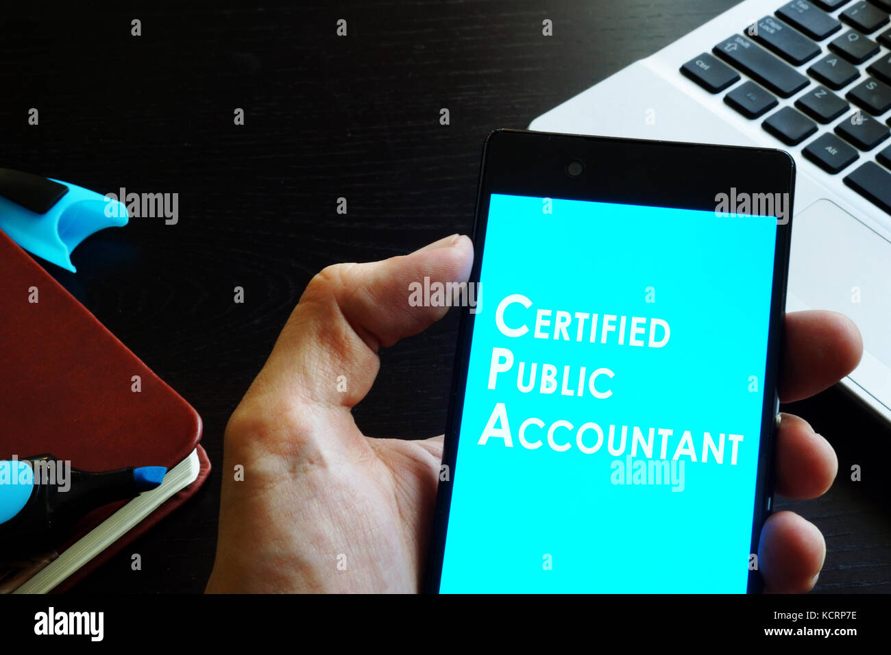 Hand holding phone with sign Certified public accountant (CPA Stock ...