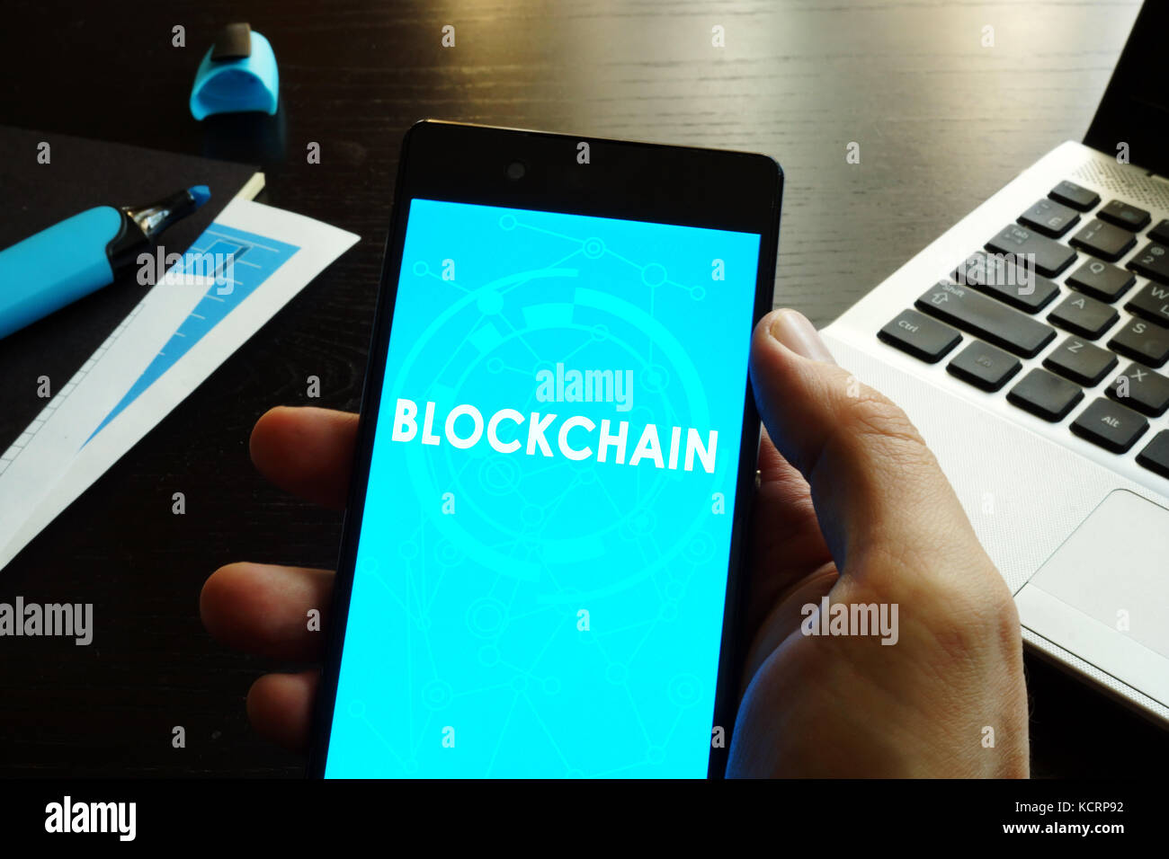 Man holding smart phone with Blockchain Stock Photo - Alamy