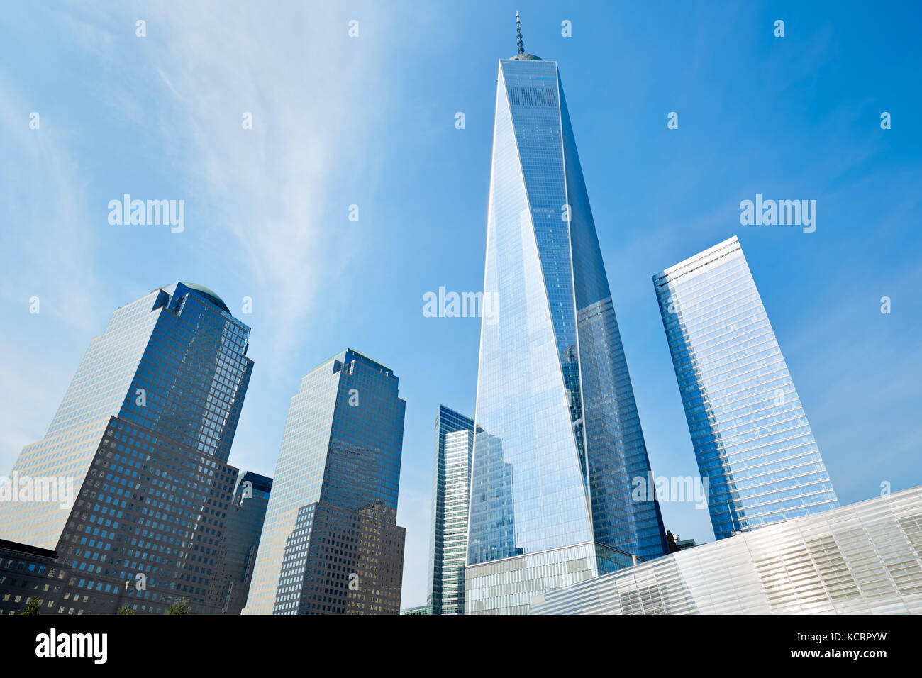 One World Trade Center skyscraper surrounded by glass buildings, blue ...