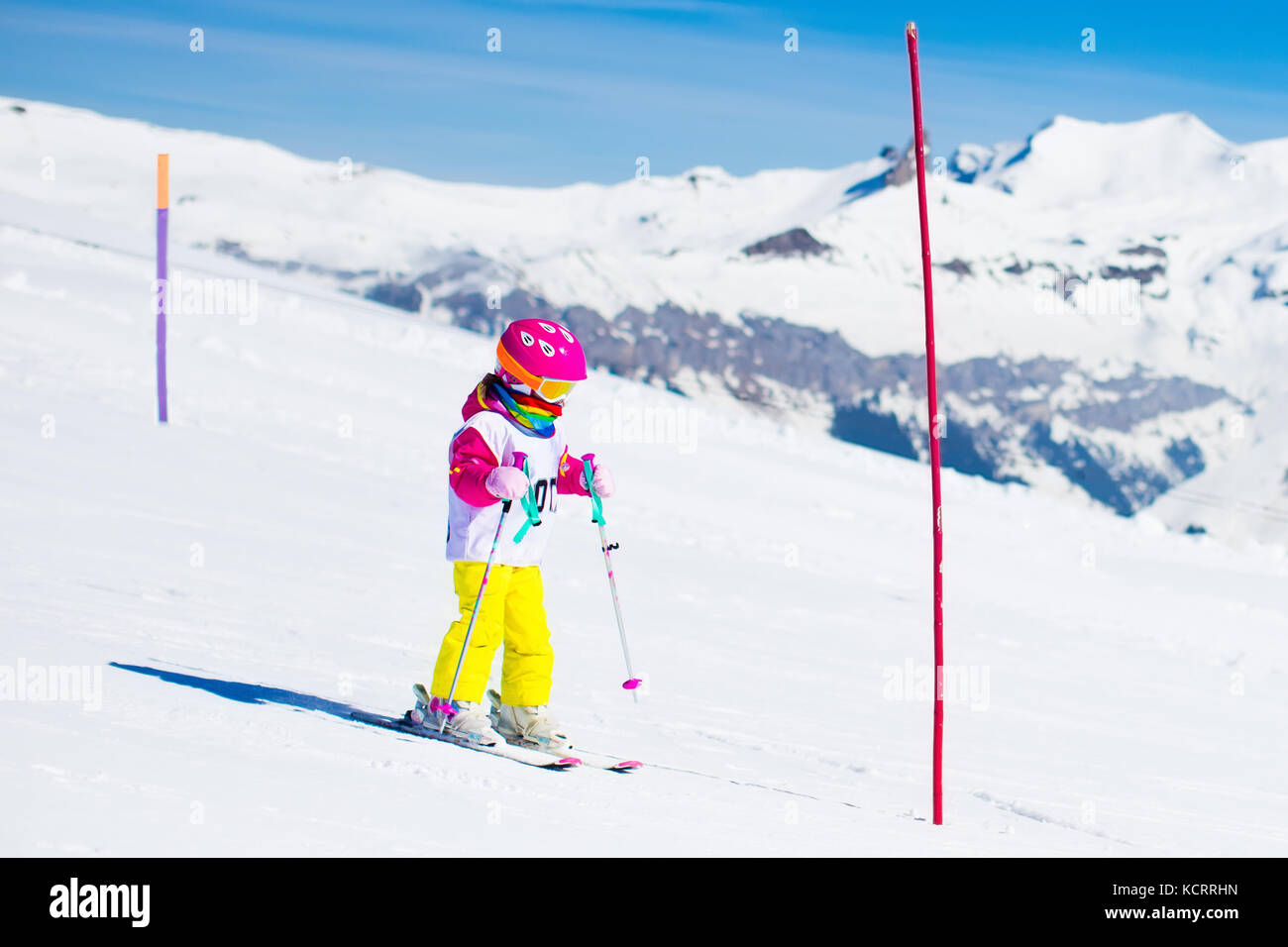Child skiing in mountains. Active toddler kid with safety helmet ...