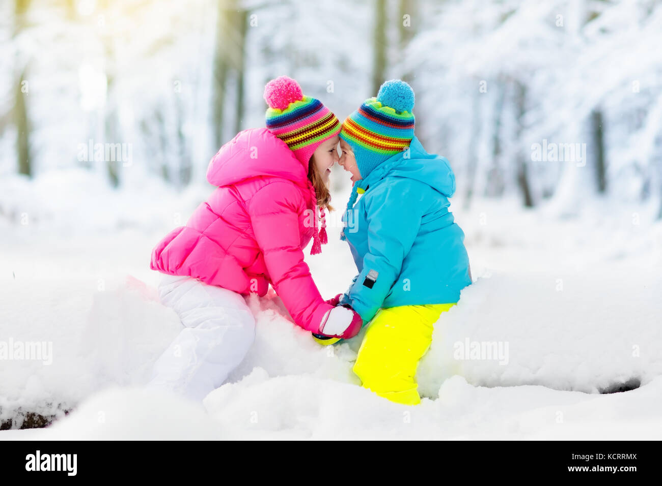 Kids playing in snow. Children play outdoors on snowy winter day. Boy ...