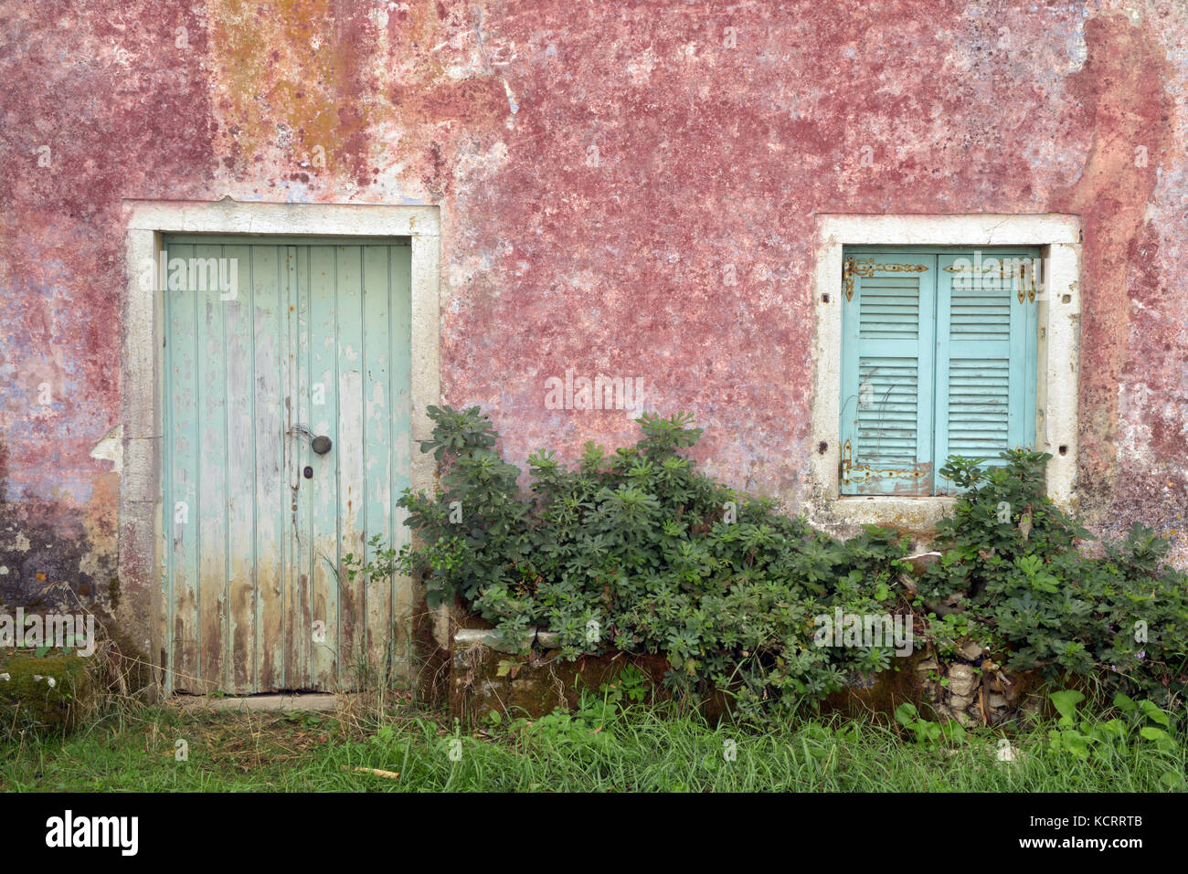 an old greek building in a poor state of repair with peeling green and ...