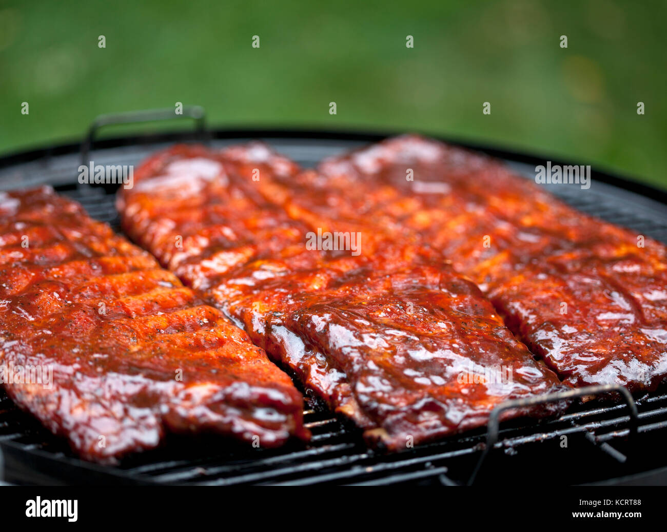 BBQ pork ribs cooking on a smoker Stock Photo - Alamy