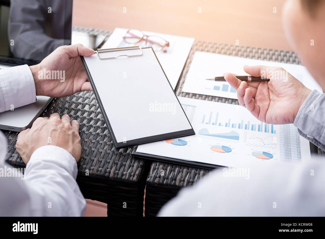 Business people discuss together about there work by graph document and ...