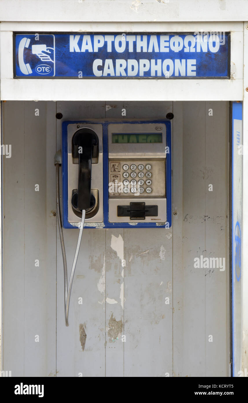 a greek public telephone box or payphone in a kiosk or cubicle with ...