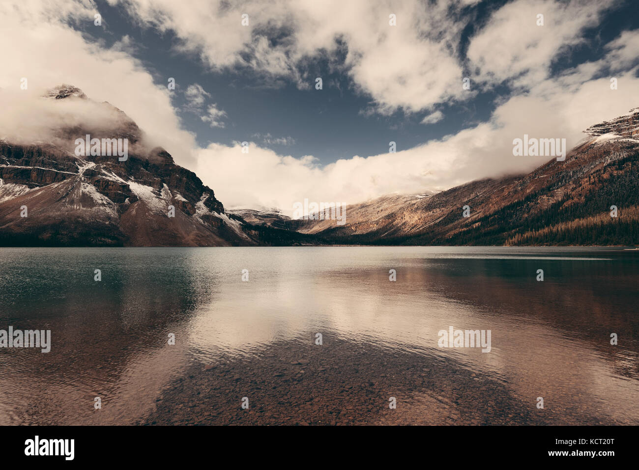 Snow Mountain with fog and lake forest Stock Photo - Alamy