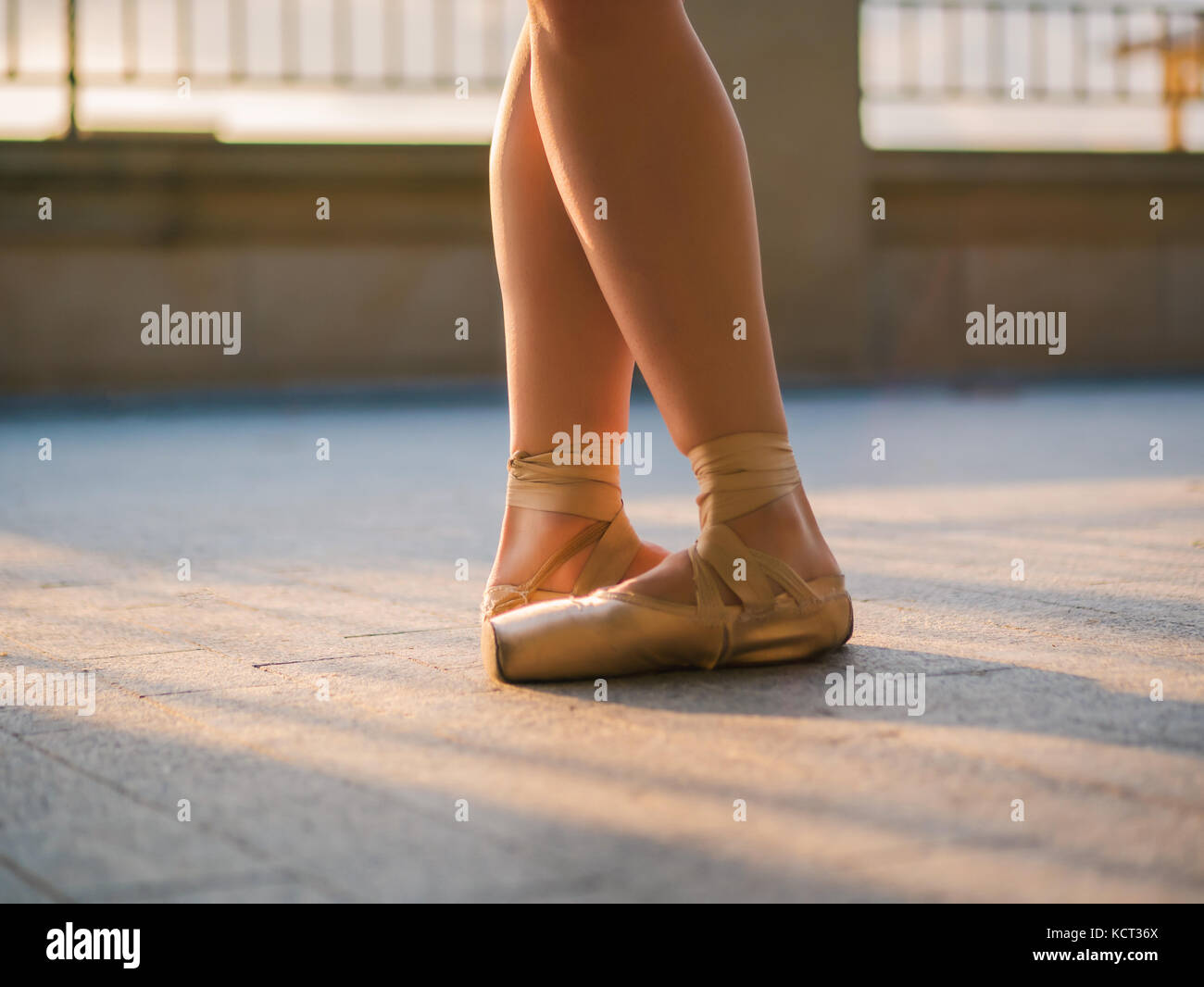Close up of a ballet dancer's feet as she practices pointe exercises on ...