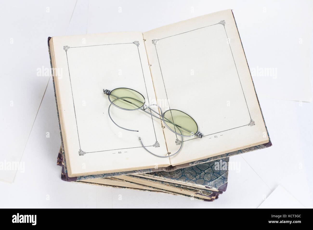 Old books with eye-glasses isolated on white background Stock Photo - Alamy