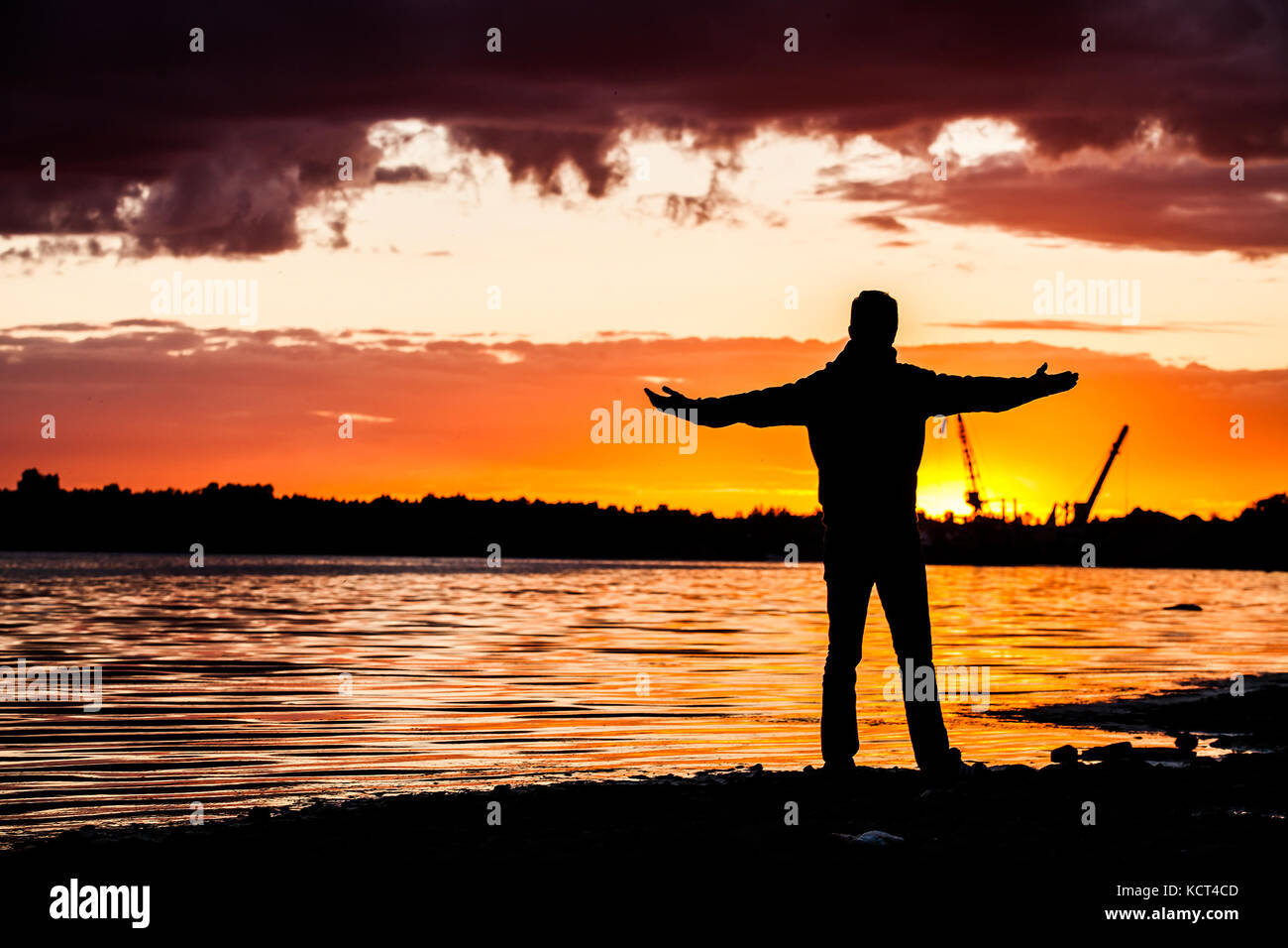 Happy celebrating winning success woman at sunset or sunrise standing ...